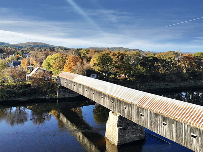 The bridge's distinctive silhouette creates a perfect frame for the vibrant fall foliage that makes New England famous worldwide.