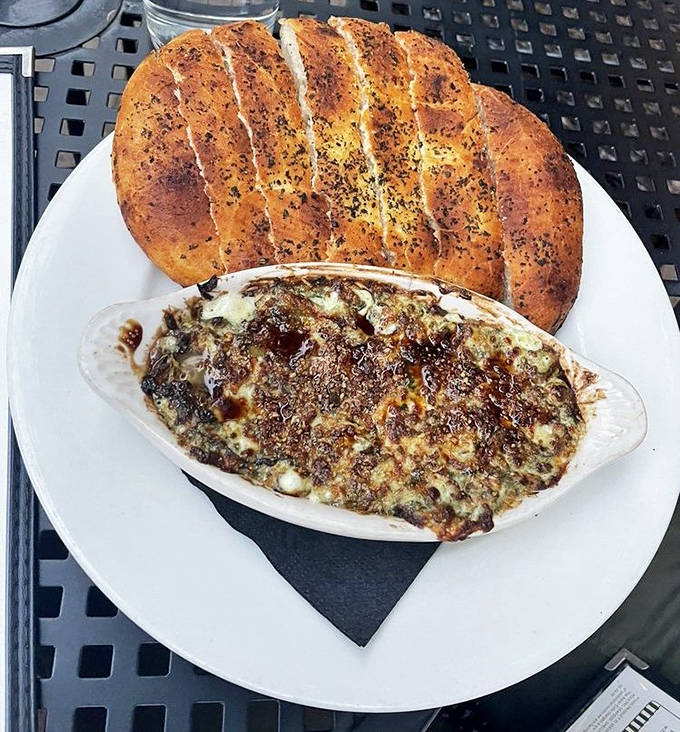 That moment when the artichoke dip arrives bubbling hot, ready to be scooped up with fresh-baked bread – resistance is futile, folks.