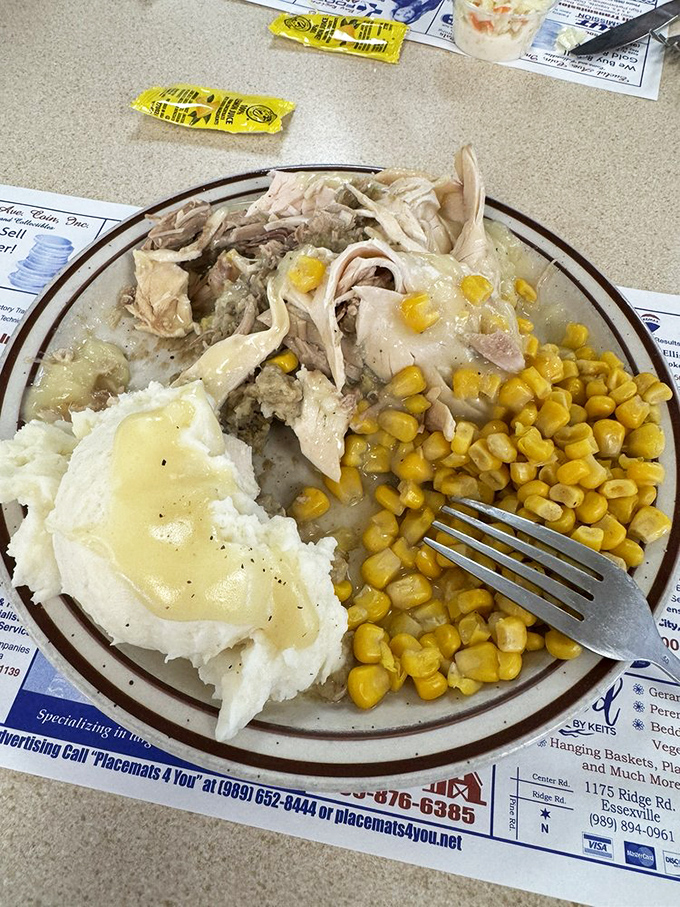 Thanksgiving on a plate! Tender turkey, buttery mashed potatoes, sweet corn, and gravy that could make a vegetarian reconsider life choices.