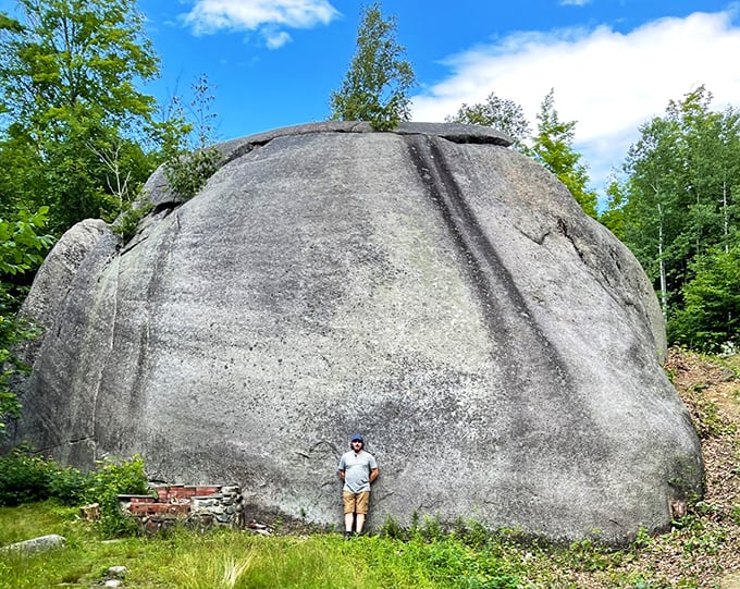 The person at the base offers startling perspective &ndash; this isn't just a boulder, it's practically a small mountain with its own zip code.
