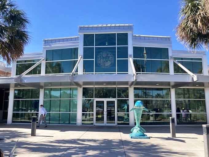 The modern Welcome Center building gleams with glass and promise, ready to answer every question from "where's the nearest beach" to "seriously, how many theme parks are there?"
