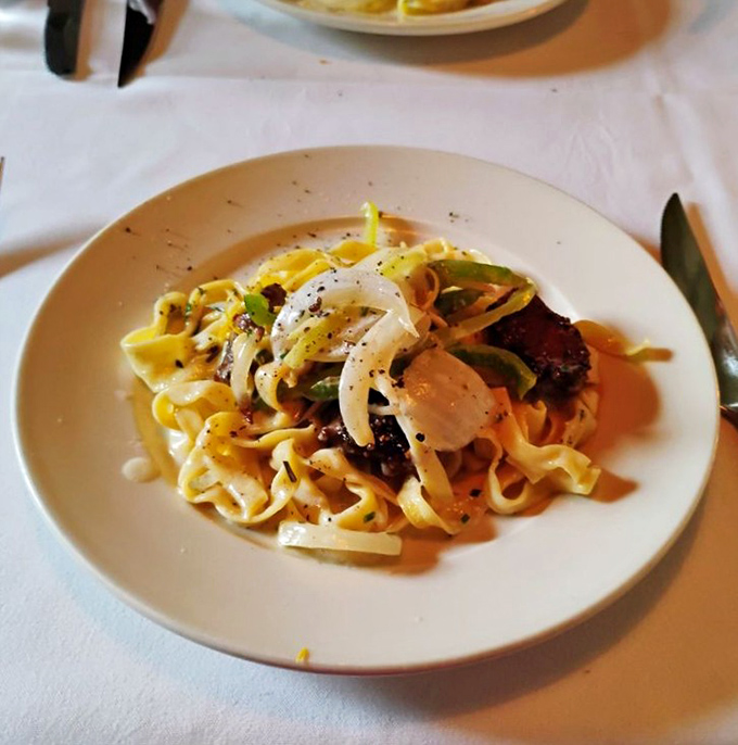 This isn't just pasta &ndash; it's a silky ribbon dance of fettuccine embracing tender morsels in a symphony that makes forks pause mid-air.