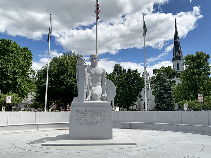 The Youth memorial statue stands sentinel in Barre's town square, carved from the very granite that built this community.