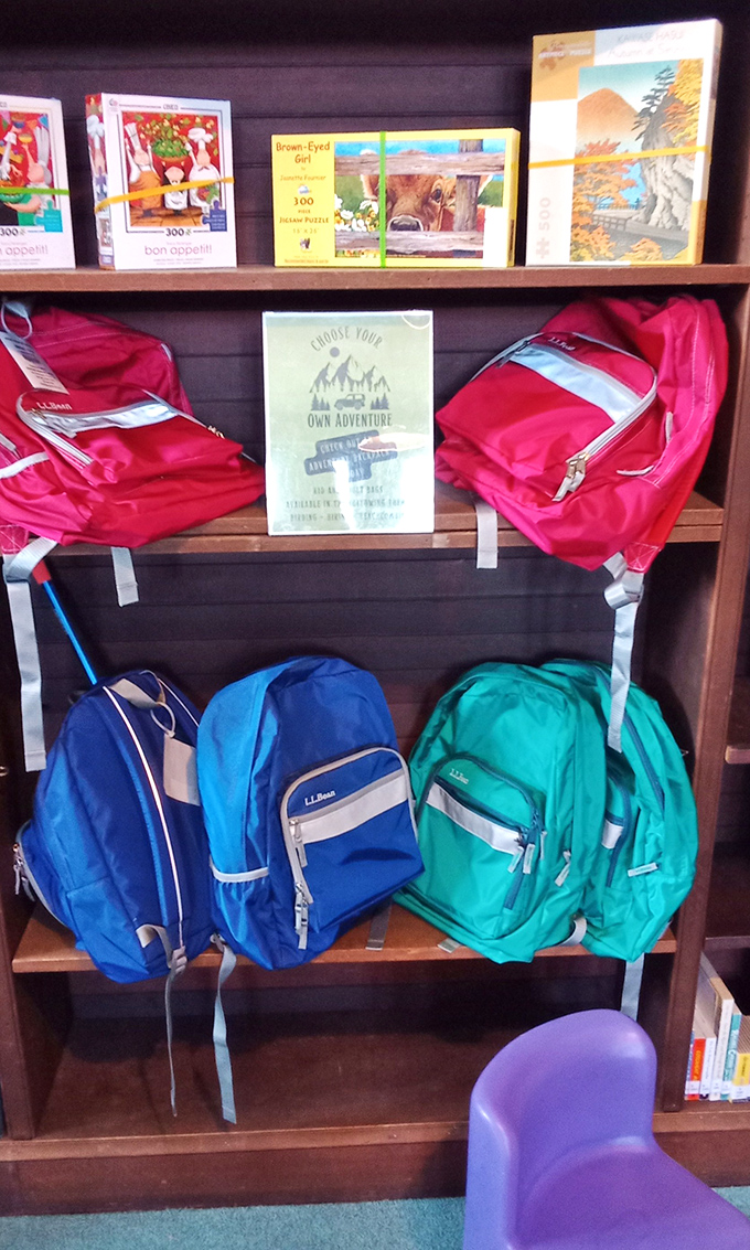 Adventure awaits! Colorful backpacks hang ready for young explorers to fill with literary treasures before embarking on imaginary journeys.