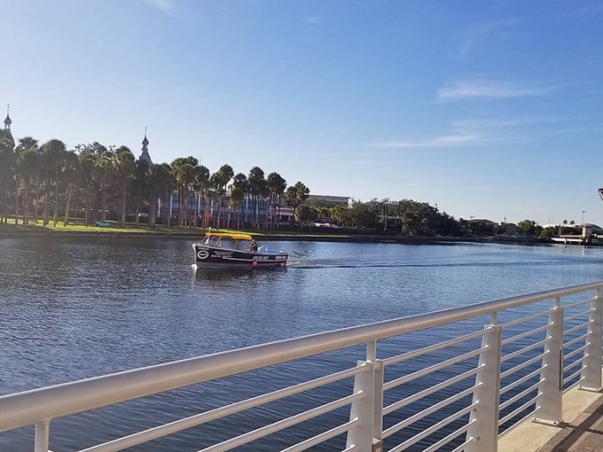 A small boat glides across the Hillsborough River, offering passengers postcard-worthy views of Tampa's waterfront from a unique perspective.