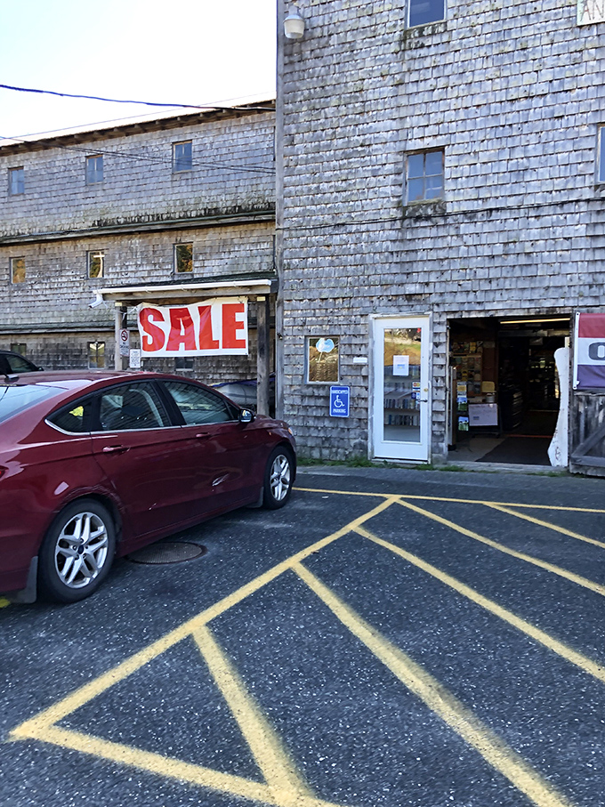 The unassuming entrance belies the wonderland within, where a simple "SALE" sign promises bargains and the weathered shingles whisper of history.