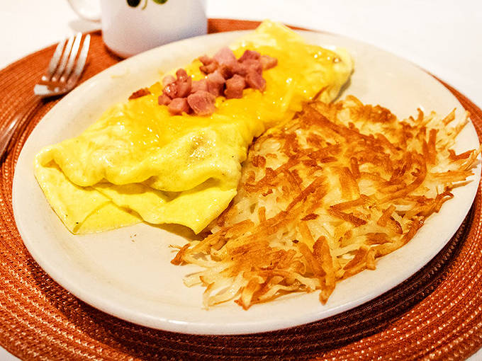 This ham and cheese omelet isn't just breakfast&mdash;it's a fluffy yellow miracle alongside perfectly crispy hash browns that would make any potato proud.