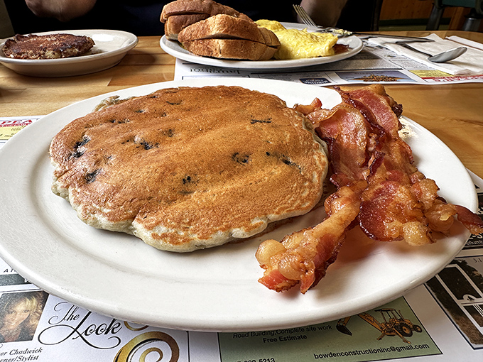 Blueberry pancakes that would make your grandmother weep with joy, paired with bacon that shatters perfectly with each bite.