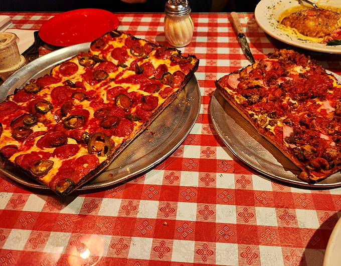 Detroit-style pizza perfection: crispy caramelized edges, fluffy interior crust, and that signature sauce-on-top approach that makes pizza purists swoon with delight.