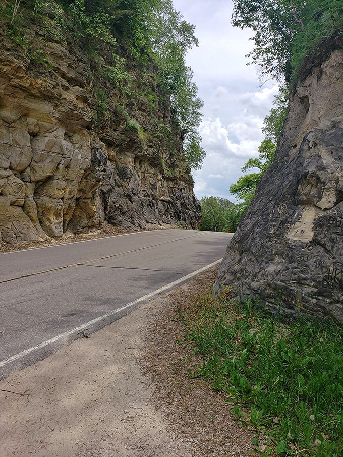 The smooth asphalt belies the brutal effort that created this passage – each inch representing countless pickaxe strikes and wheelbarrow loads.