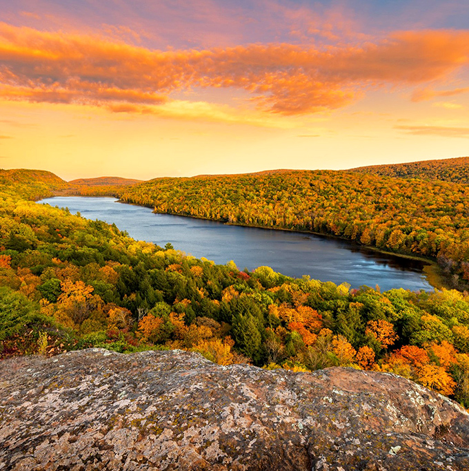 Fall transforms the Porcupine Mountains into a kaleidoscope of colors, with the lake providing a stunning blue centerpiece.