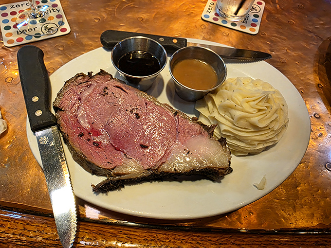 A perfectly cooked prime rib arrives like a carnivore's dream &ndash; pink, juicy, and tender enough to cut with just a fork, accompanied by silky mashed potatoes.