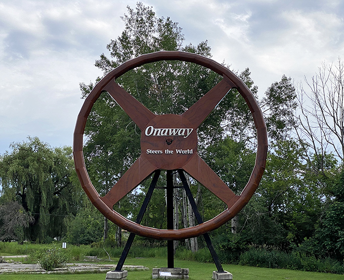 "Onaway Steers the World" proclaims this massive wheel, a monument to the site's automotive history that could guide the Titanic.