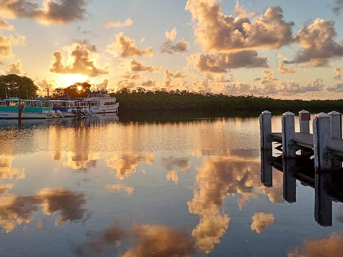 Golden hour transforms the marina into a painter's dream &ndash; boats silhouetted against clouds that look dipped in melted sherbet.