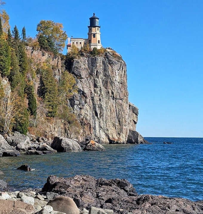 Split Rock Lighthouse stands majestically atop a rocky cliff, its iconic tower watching over Lake Superior's waters like a sentinel from another time.