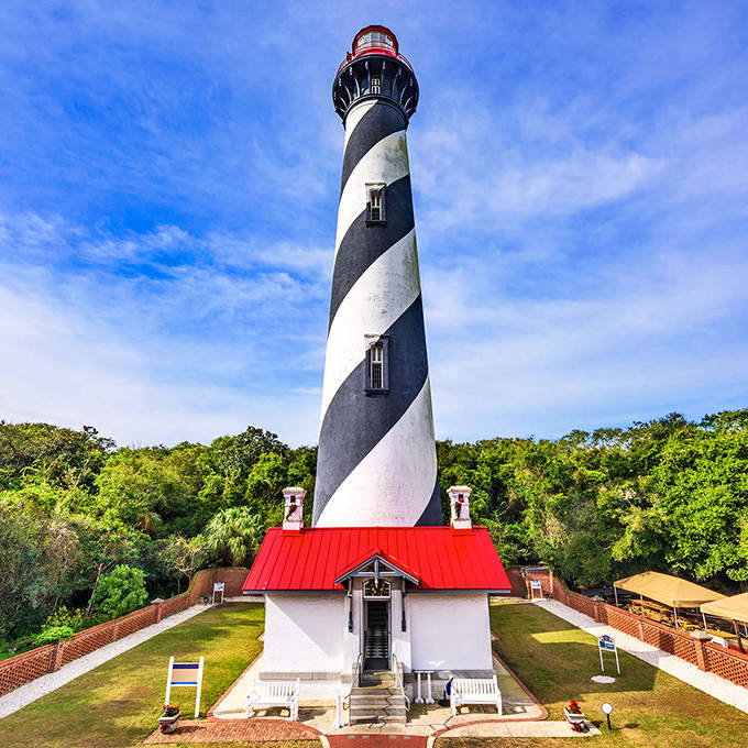 St. Augustine Light's distinctive black and white spiral pattern makes it an unforgettable landmark. The red-topped tower stands tall against the clear blue Florida sky.