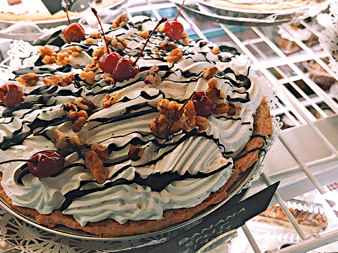 Cream pie perfection topped with clouds of whipped cream, chocolate drizzle, and crunchy nuts &ndash; a textural symphony in every bite.