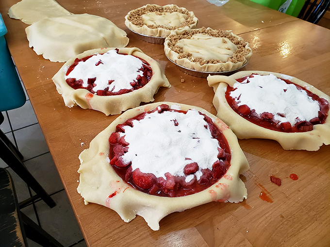 Fresh raspberry pies in various stages of creation reveal the handmade care that goes into every Vermont Apple Pie Company creation.