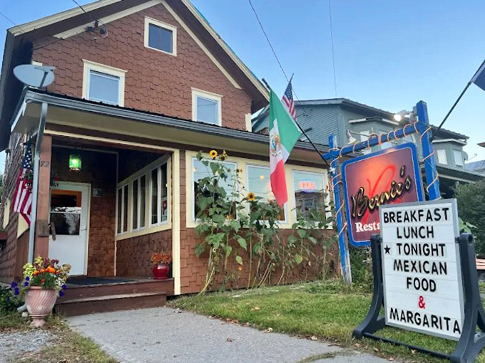 Flags flutter outside this unassuming culinary gem, where the evening sign promises a delightful identity crisis: "TONIGHT MEXICAN FOOD & MARGARITA."