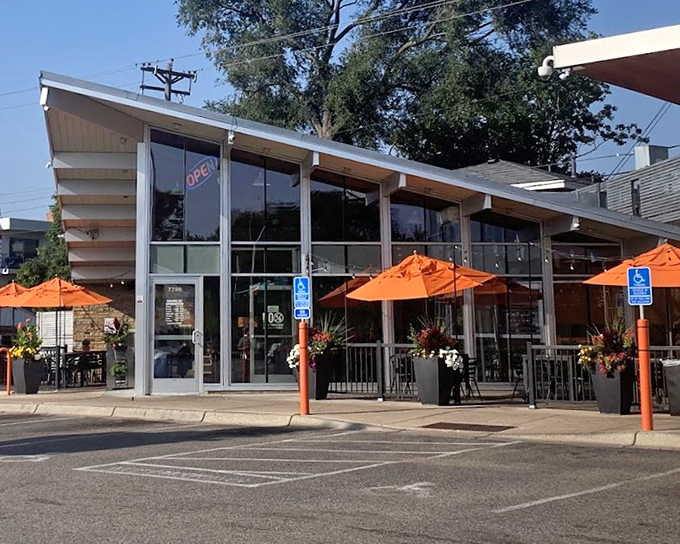 Andale Taqueria's modern storefront features large windows and bright orange umbrellas, creating an inviting atmosphere for taco enthusiasts in Richfield.