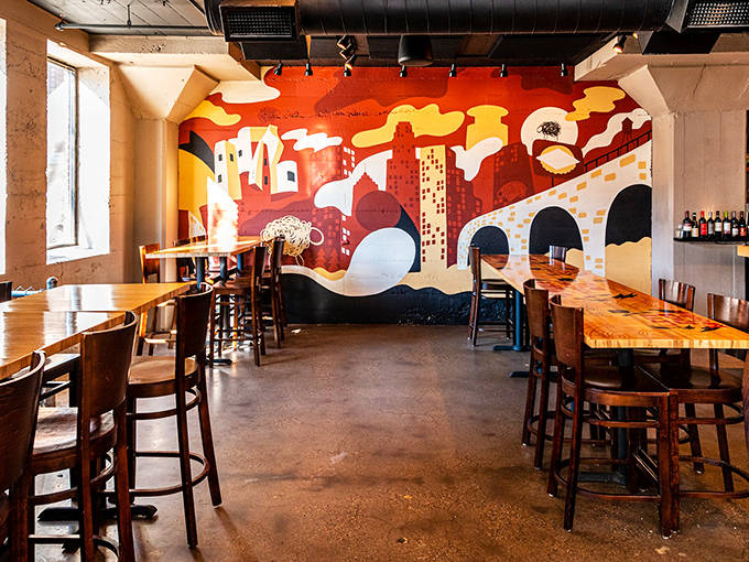 Black Sheep's artistic interior features a stunning mural of Minneapolis, creating a vibrant backdrop for their coal-fired pizza experience.