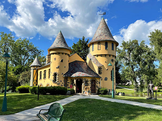 Curwood Castle's cheerful yellow walls and whimsical turrets pop against blue skies, looking more like a fairy tale illustration than an actual building.