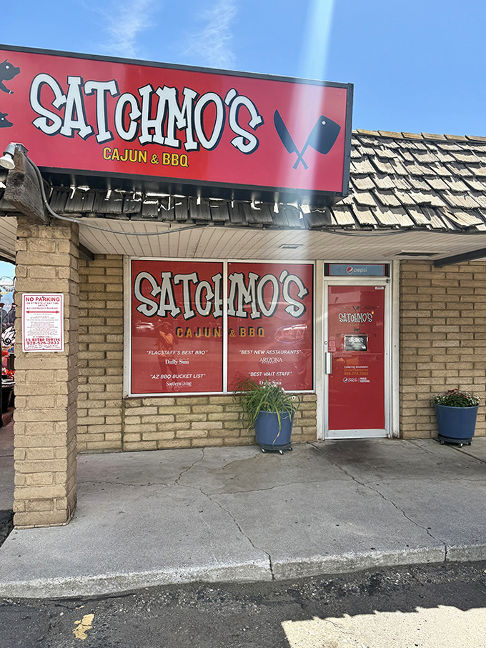 Satchmo's bright red signage promises a delicious fusion of Cajun and BBQ flavors in the heart of Flagstaff.