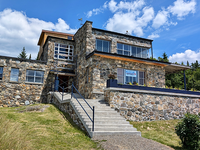 The stone-built Wilhelm Reich Museum stands proudly against blue skies, its rustic architecture blending history and science in Maine's mountains.