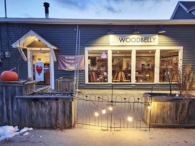 Woodbelly Pizza's cozy exterior glows with warm light, beckoning pizza enthusiasts to discover their farm-to-table creations.