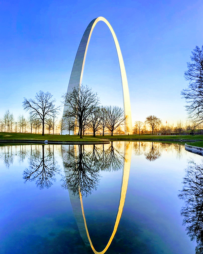 The Arch's perfect reflection doubles the visual impact of America's tallest monument, a modern marvel along the historic Route 66.