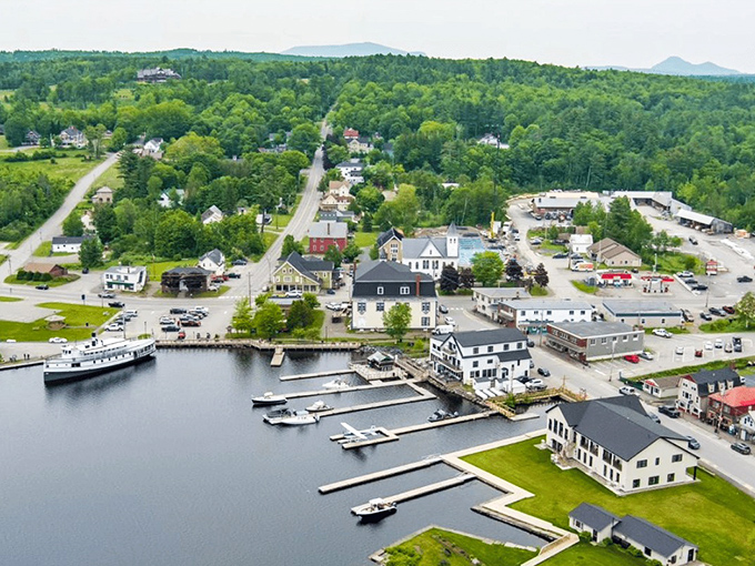 An aerial view of Greenville reveals its perfect placement between forest and water, with docks extending into the pristine lake.