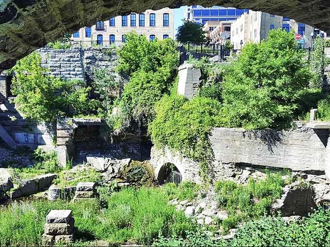 Stone walls frame sky where mill workers once toiled, Minneapolis's industrial past now a playground for history buffs and photographers.