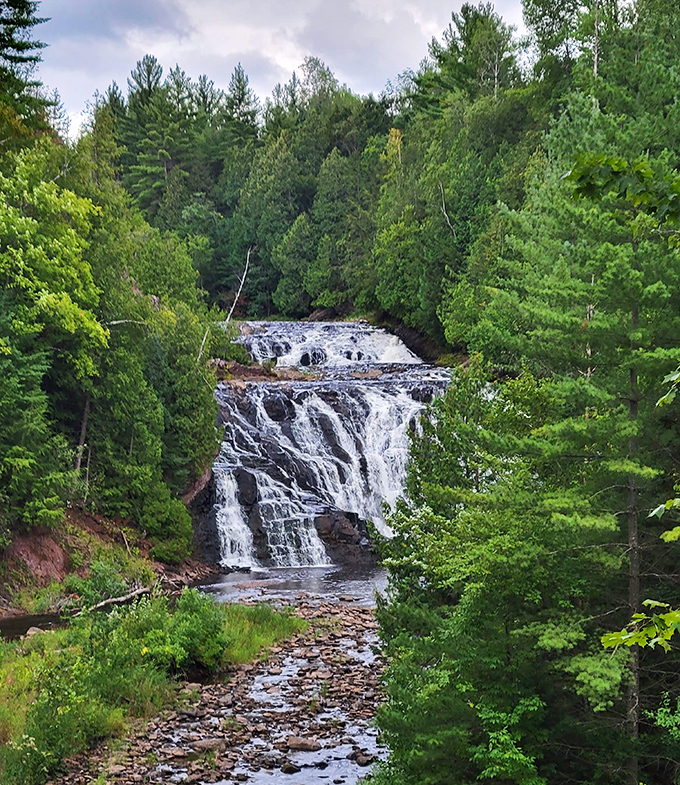 The multi-tiered cascades of Potato River Falls create a natural staircase of rushing water, surrounded by the rich autumn colors of Wisconsin's northwoods.