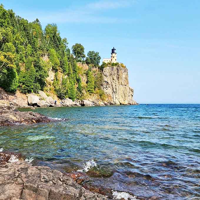 The historic lighthouse perches dramatically above Lake Superior's clear waters, offering views that stretch for miles.