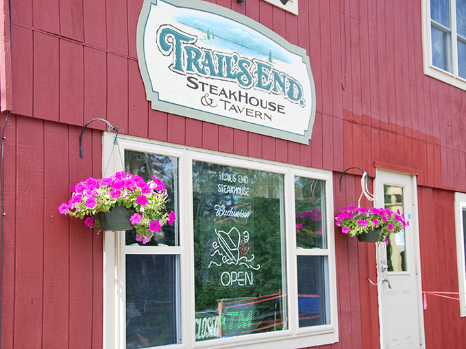 Bright pink flowers add a pop of color to Trail's End Steakhouse's windows, welcoming hungry hikers and snowmobilers year-round.