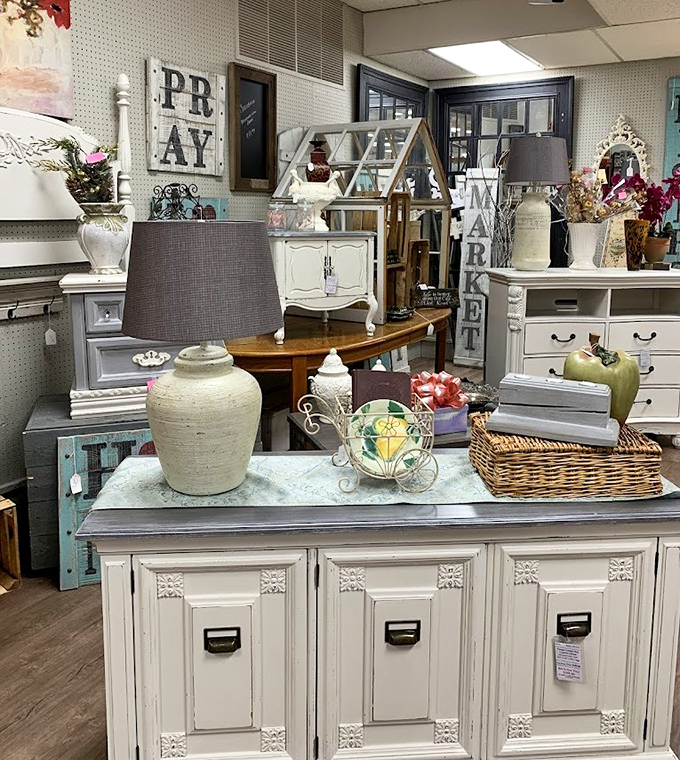 Shabby chic meets vintage charm in this furniture display. That white cabinet has probably seen more family secrets than a therapist.