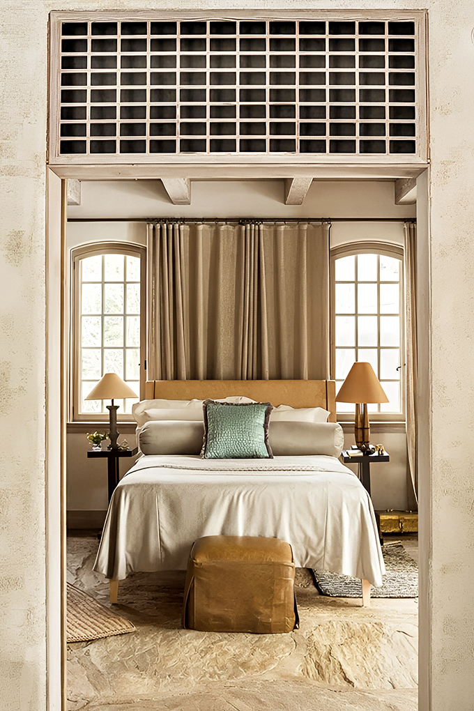 Neutral tones and natural light create a serene bedroom sanctuary, where comfort meets sophisticated design.