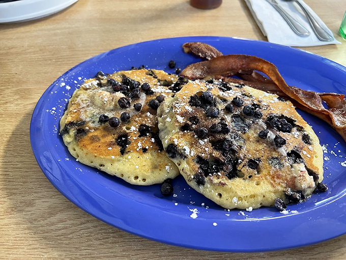 Blueberry pancakes that capture Maine's essence, paired with bacon that's achieved that perfect crispy-chewy balance.