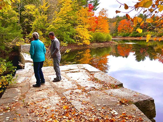 Autumn's palette reflects perfectly in Cascade Pond, doubling nature's show in a mirror that ripples with every gentle breeze.
