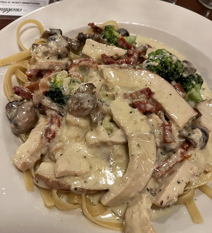 Fettuccine that would make nonna proud, laden with chicken, broccoli, and mushrooms in a cream sauce that defies gravity.
