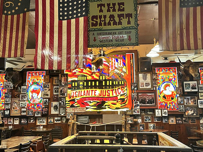 Colorful "Vigilante Justice" artwork and vintage flags create an atmosphere where history feels deliciously present.