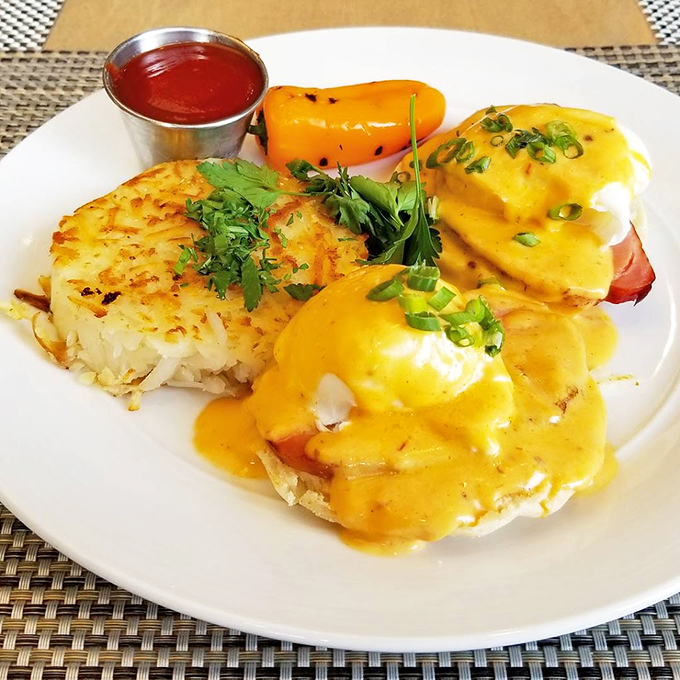 Eggs Benedict gets the Southwest treatment with vibrant hollandaise cascading down like a sunrise over the desert mountains.