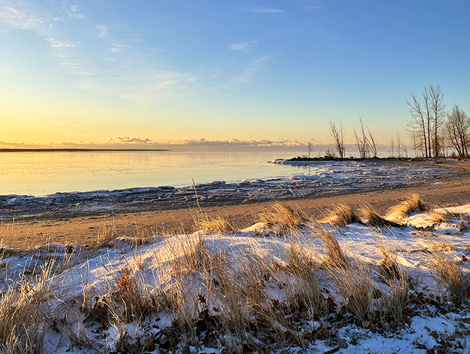 5. escanaba municiEscanaba Municipal Beach offers pristine shoreline views where winter transforms the landscape into a serene wonderland of snow and ice.pal beach