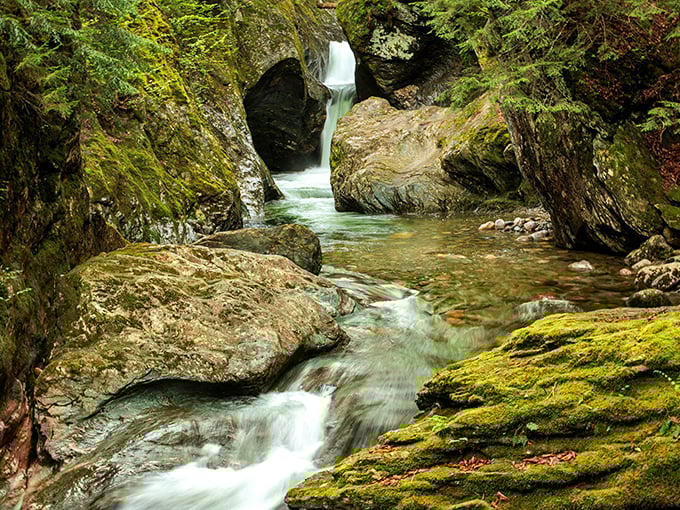 Crystal clear waters tumble between moss-draped rocks, creating nature's perfect spa soundtrack.