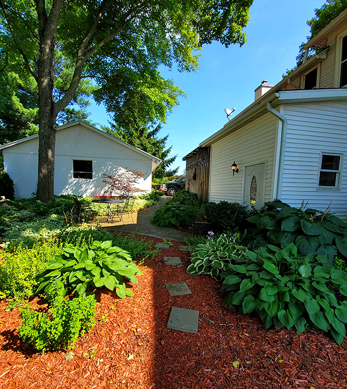 Garden pathways invite leisurely exploration, with stone steps leading through lush greenery to hidden corners perfect for afternoon reading.