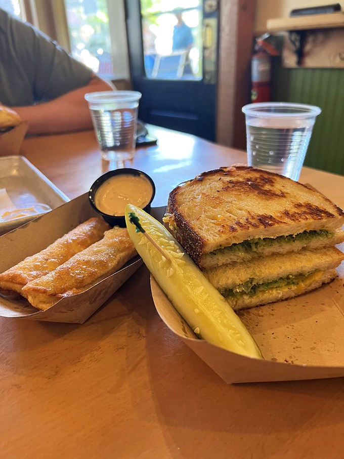 The Green Goddess Grilled Cheese arrives with its perfect companion &ndash; a pickle spear that's not an afterthought but a co-star in this culinary show.