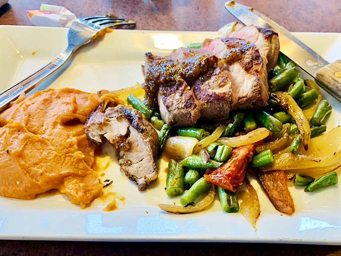 Perfectly pink-centered pork shares the spotlight with vibrant vegetables and sweet potato mash that tastes like autumn's greatest hits.