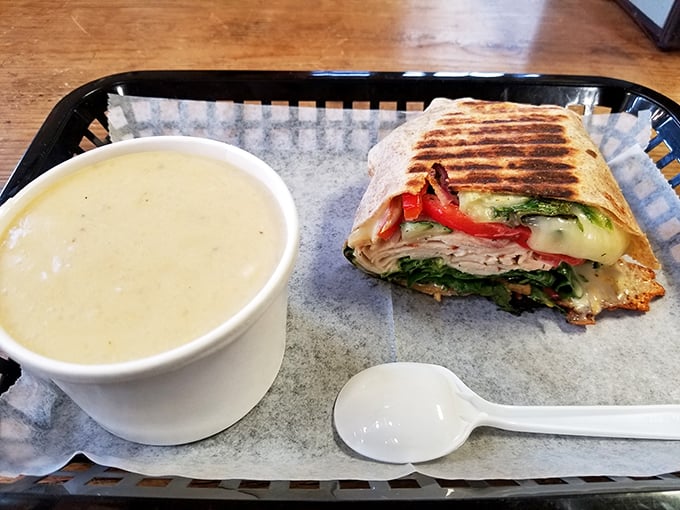 A grilled wrap sandwich paired with creamy soup &ndash; comfort food elevated to an art form in this greenhouse setting.