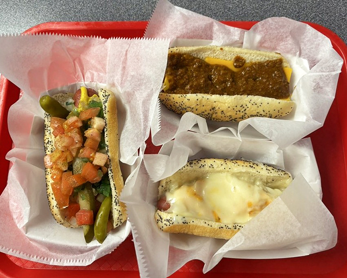 A tray of hot dog heaven – these aren't just meals, they're edible nostalgia served on poppy seed buns with all the fixings.