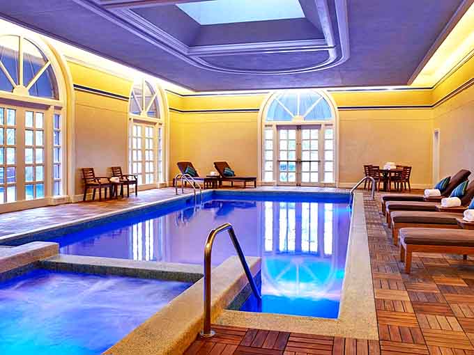 Sunshine streams through arched windows onto crystal blue waters &ndash; the indoor pool area feels like a Mediterranean escape in Michigan.